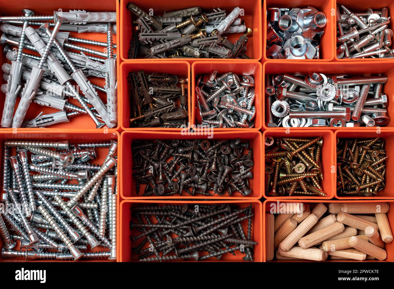 Red tool box with square compartments with screws and dowels Stock ...