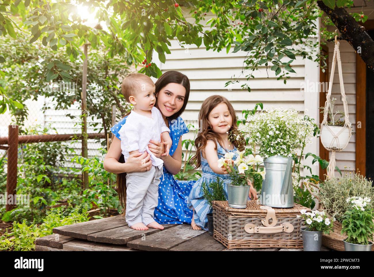 Young delighted mother sitting in armchair with adorable little ...