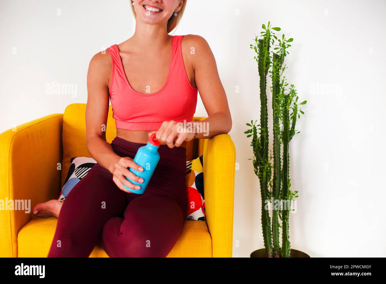 Crop Positive Fit Female In Sportswear Holding Plastic Bottle Of Fresh