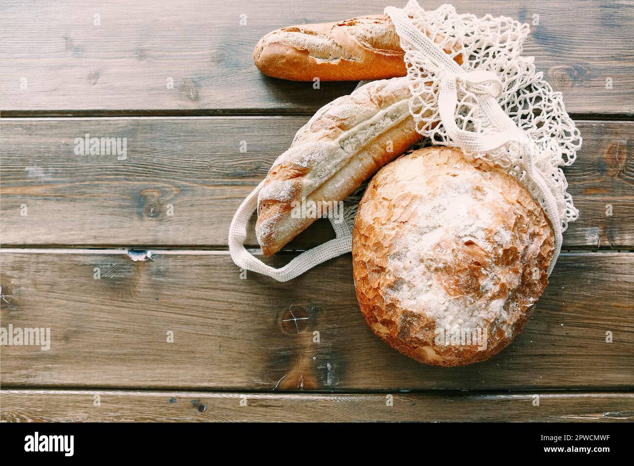 Top view of three loaves of different varieties of freshly bought bread ...