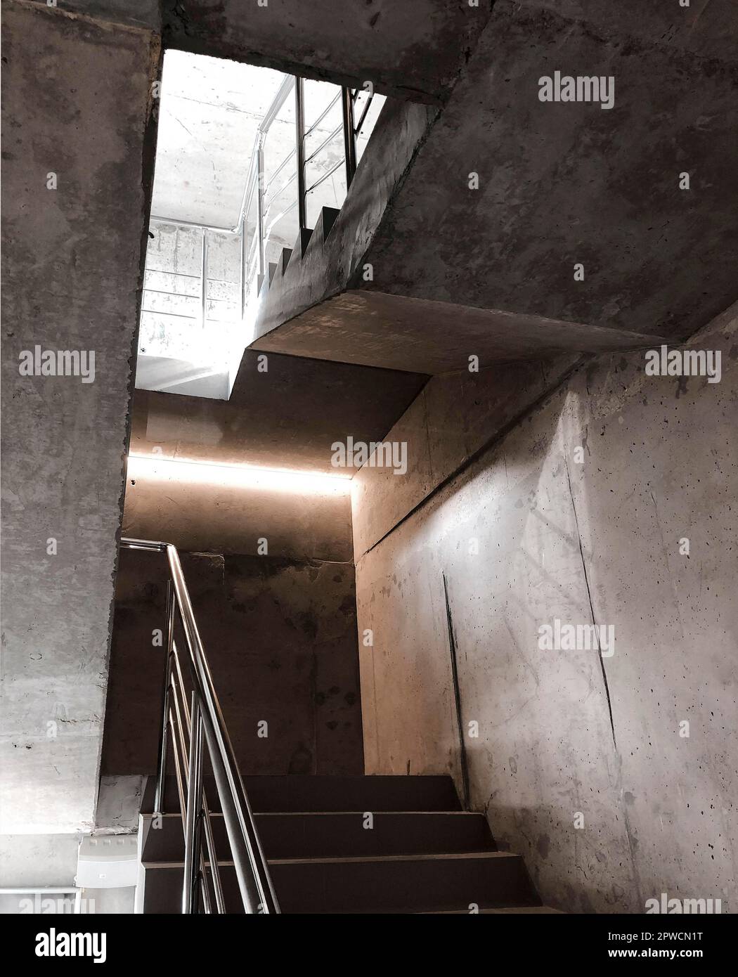 Abstract photo of empty modern rough concrete staircase with steel ...