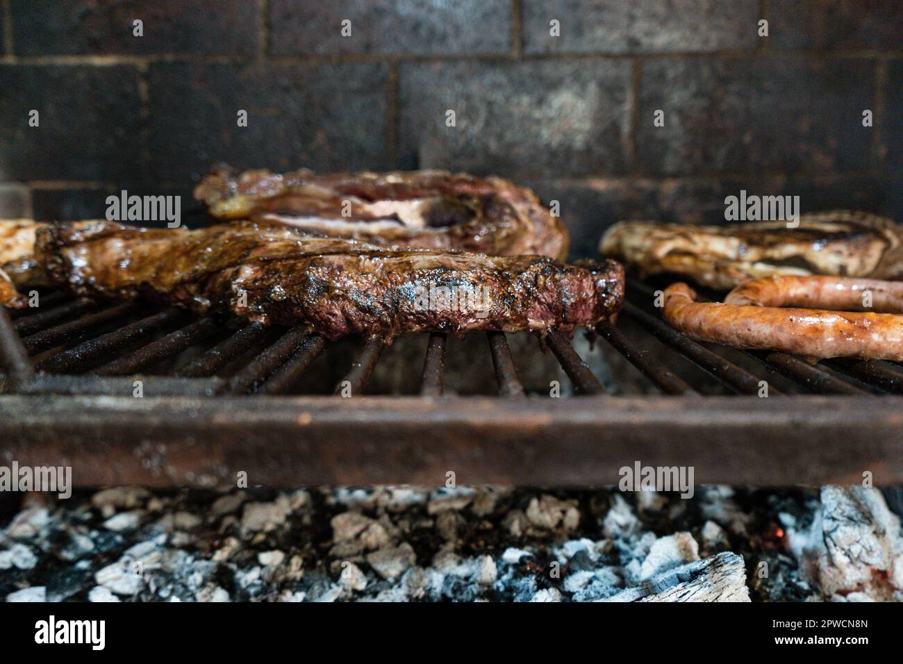 Grilled meat in the barbecue grill. Argentinian grill style Stock Photo ...