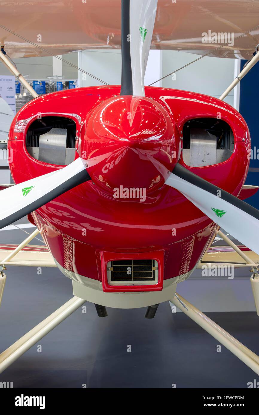 The front part of the aircraft with the propeller with red engine ...