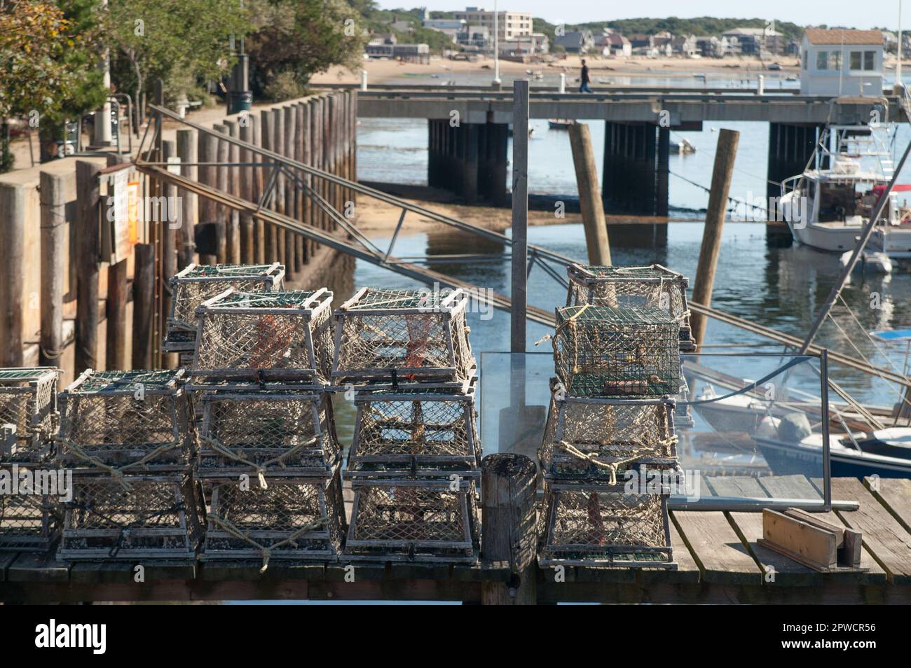 Lobster traps stacked on fishing pier Stock Photo - Alamy