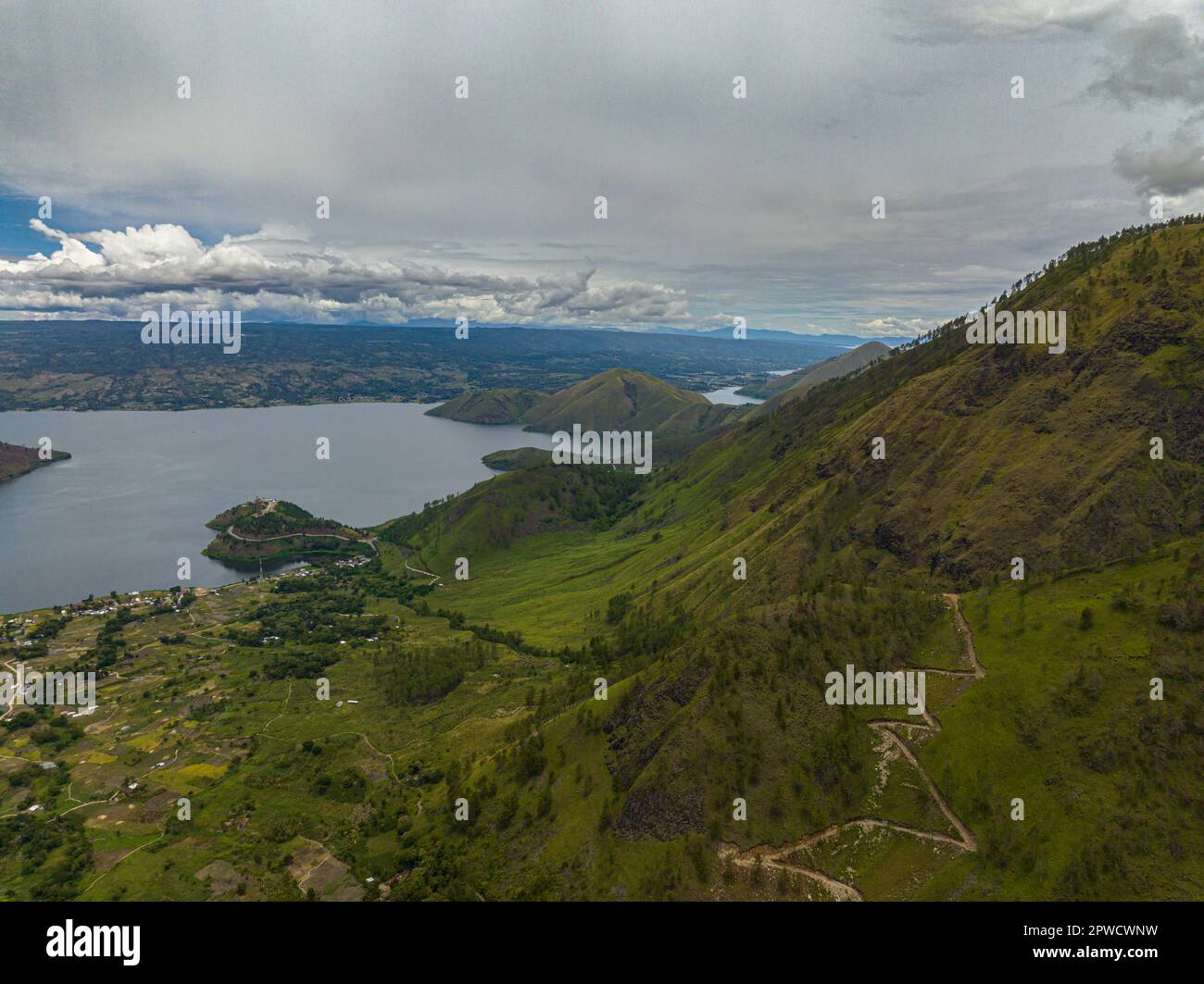 Aerial drone of mountains with forest and Lake Toba. Samosir Island ...