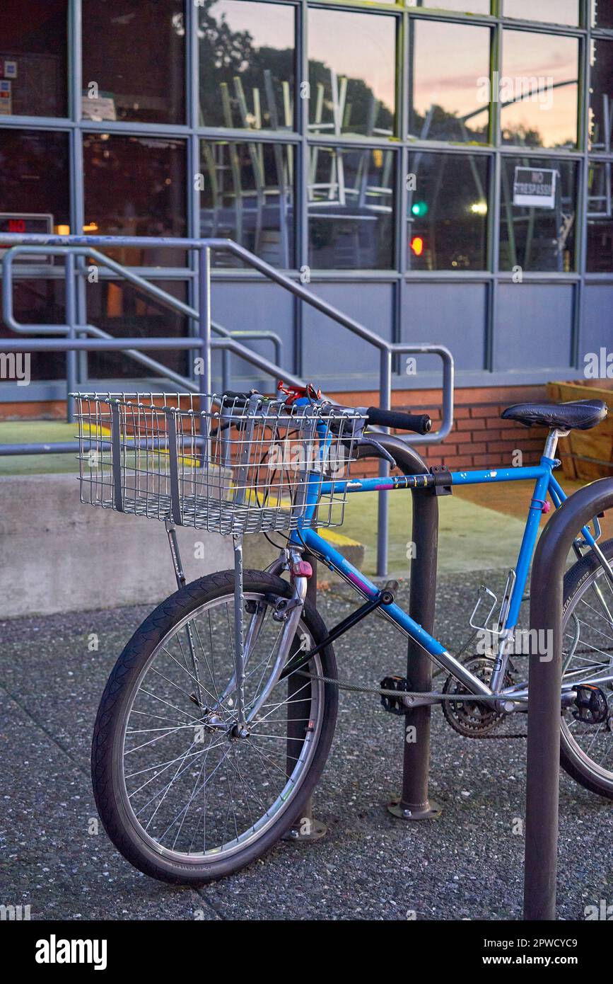 Blue bicycle locked to a post on a sidewalk in downtown Santa Rosa, California Stock Photo - Alamy