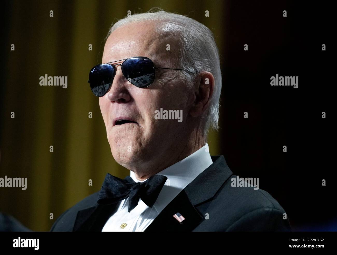 President Joe Biden wears sunglasses after making a joke about becoming ...