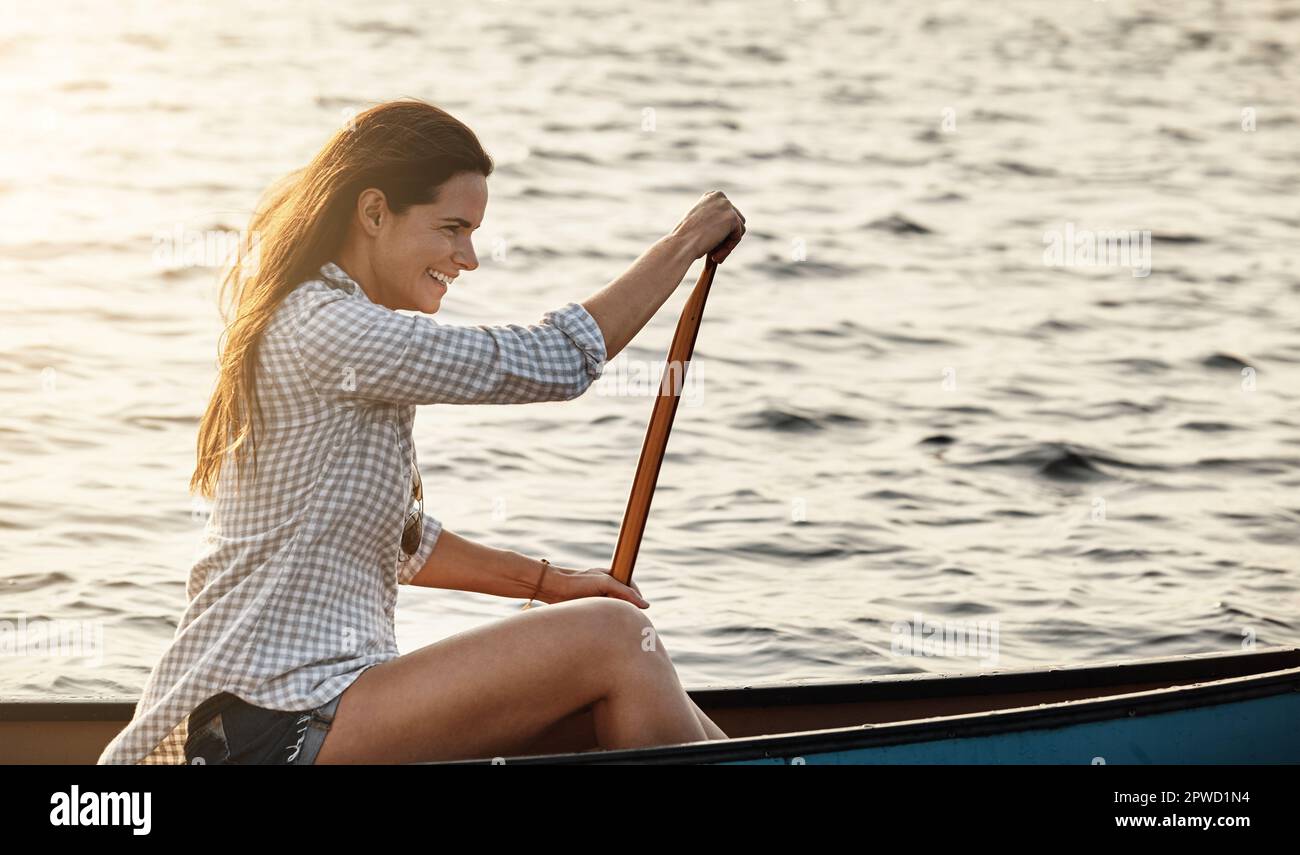She loves the feeling rowing gives her. a beautiful young woman rowing ...