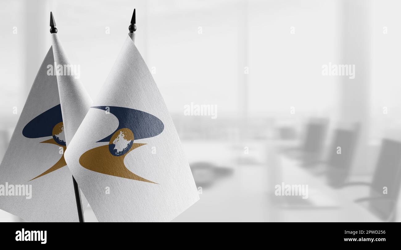 Small flags of the Eurasian Economic Union on an abstract blurry ...