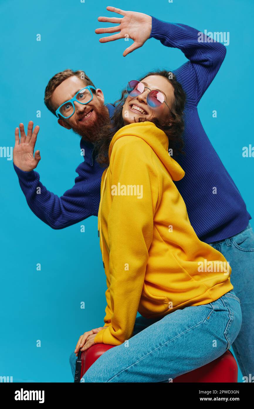 Woman and man smile sitting on suitcase with red suitcase smile, on ...