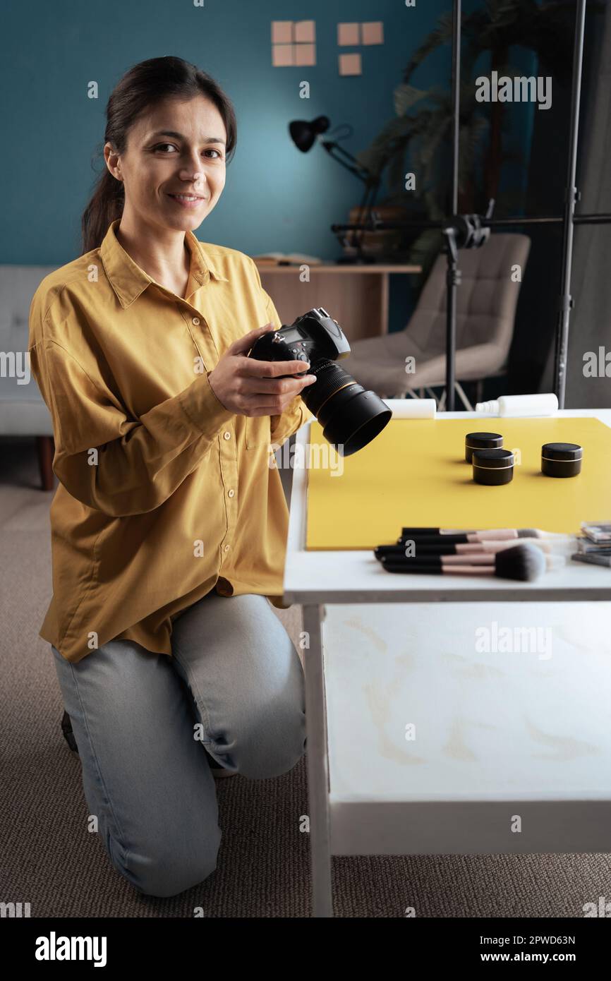 Professional photographer. Portrait of smiling hispanic woman with slr ...