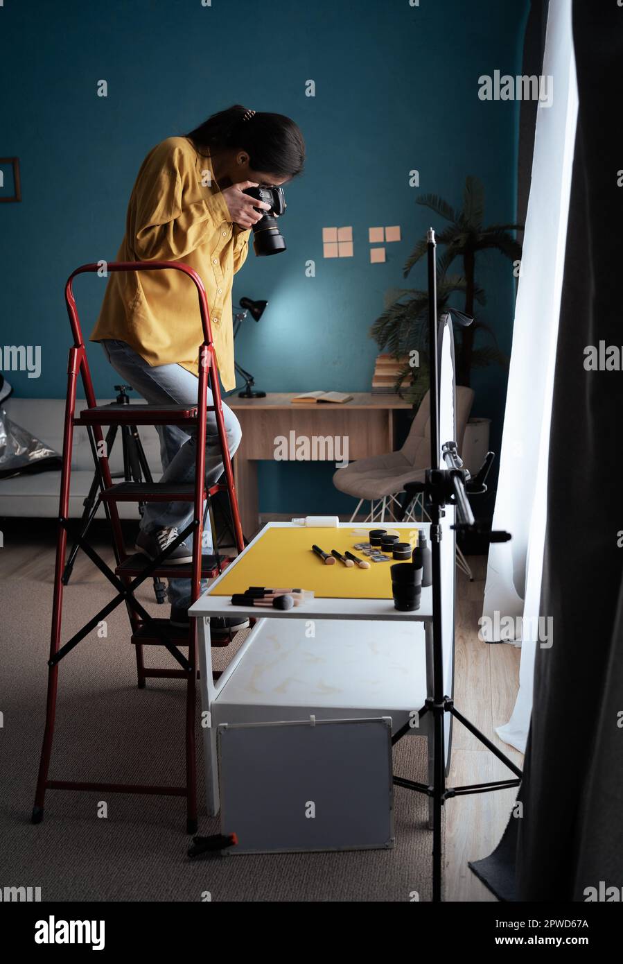 Female photographer with professional camera taking beauty cosmetics ...