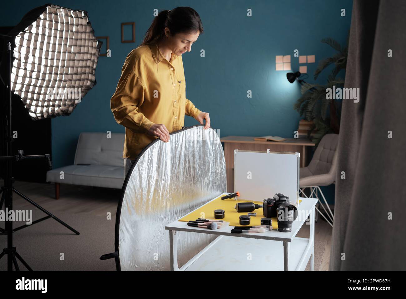 Professional photographer taking picture of beauty products in home ...