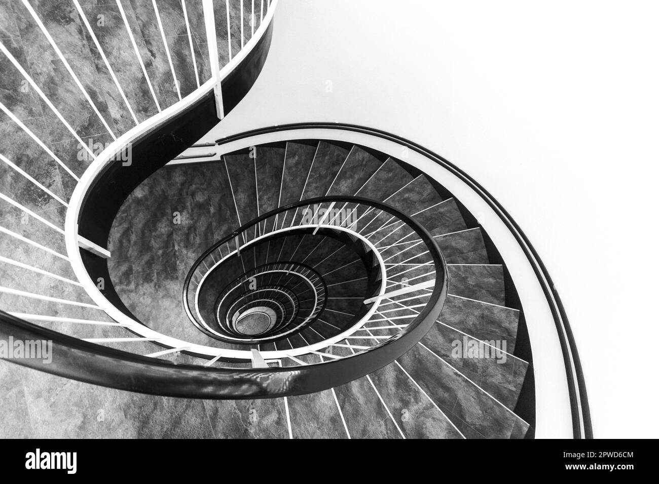 Sprial staircase forming a beautiful shell pattern with white wall for ...