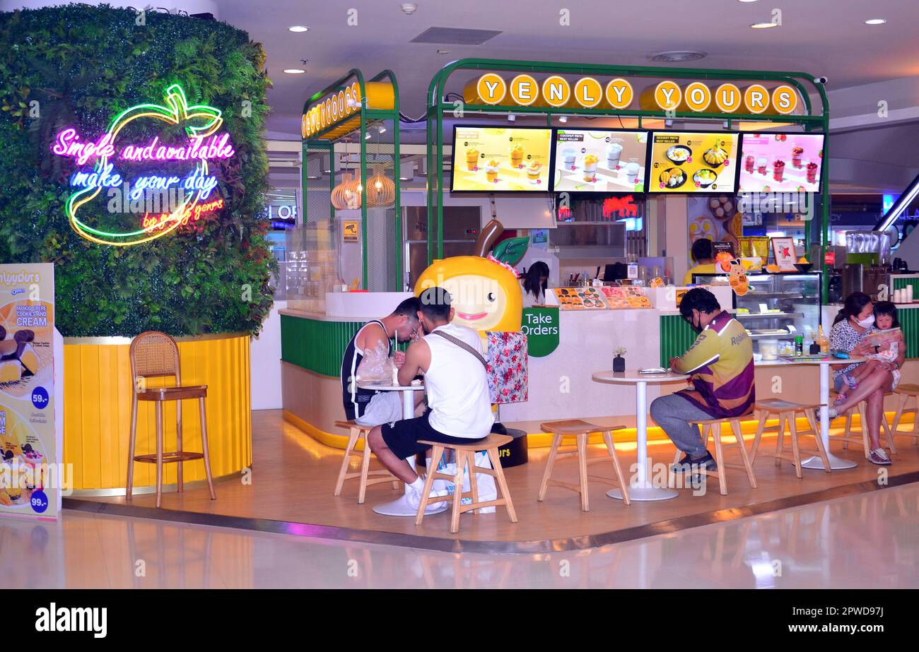 People sit at tables at the Yenly Yours drinks and eatery outlet in ...