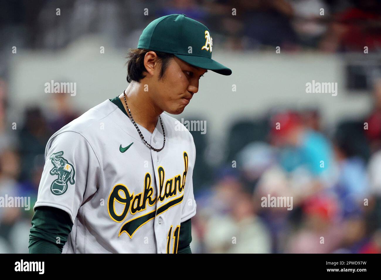 Oakland Athletics starting pitcher Shintaro Fujinami (11) walks back to ...