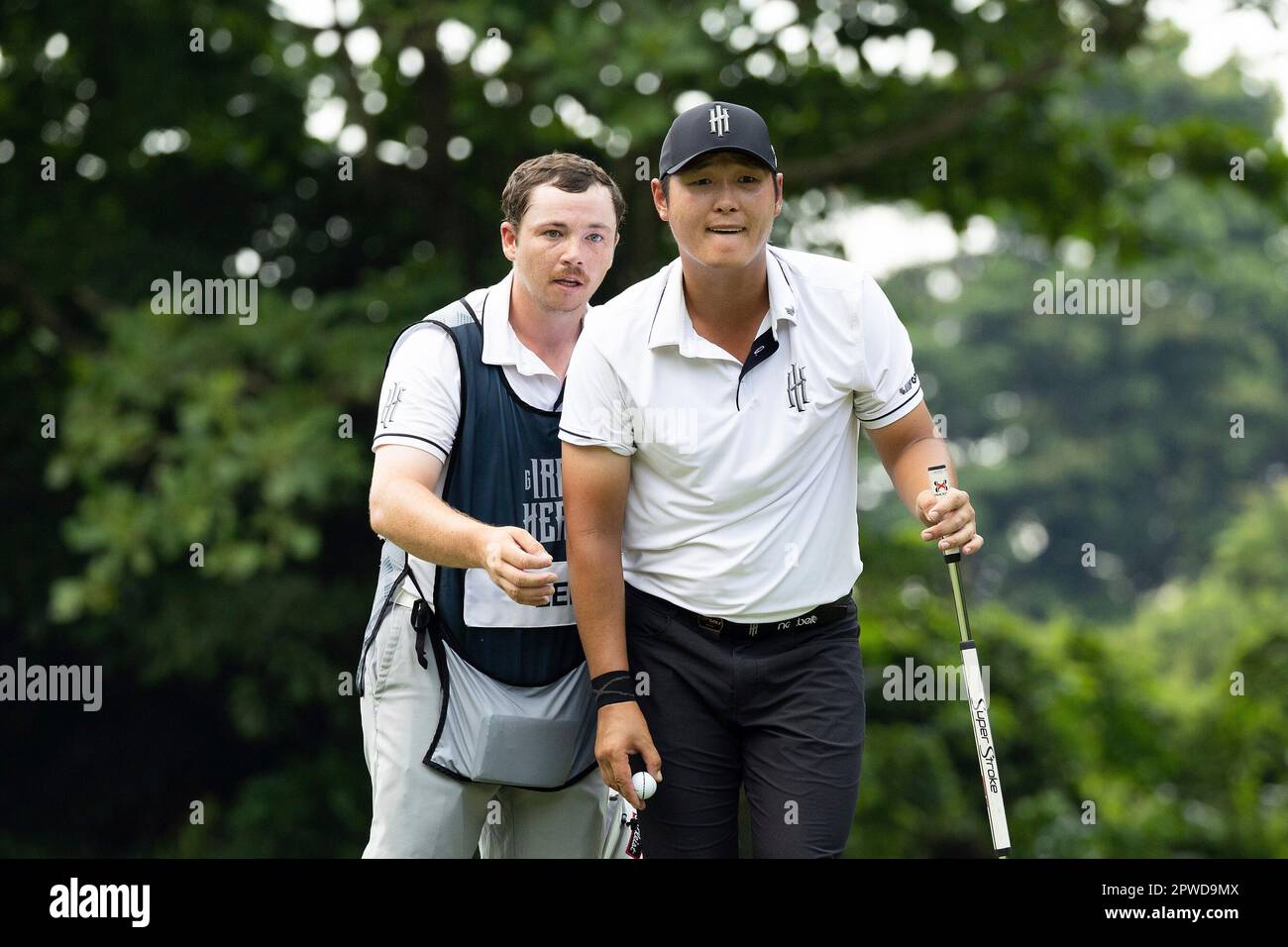 Danny Lee of Iron Heads GC talks with his caddie on the 11th green ...