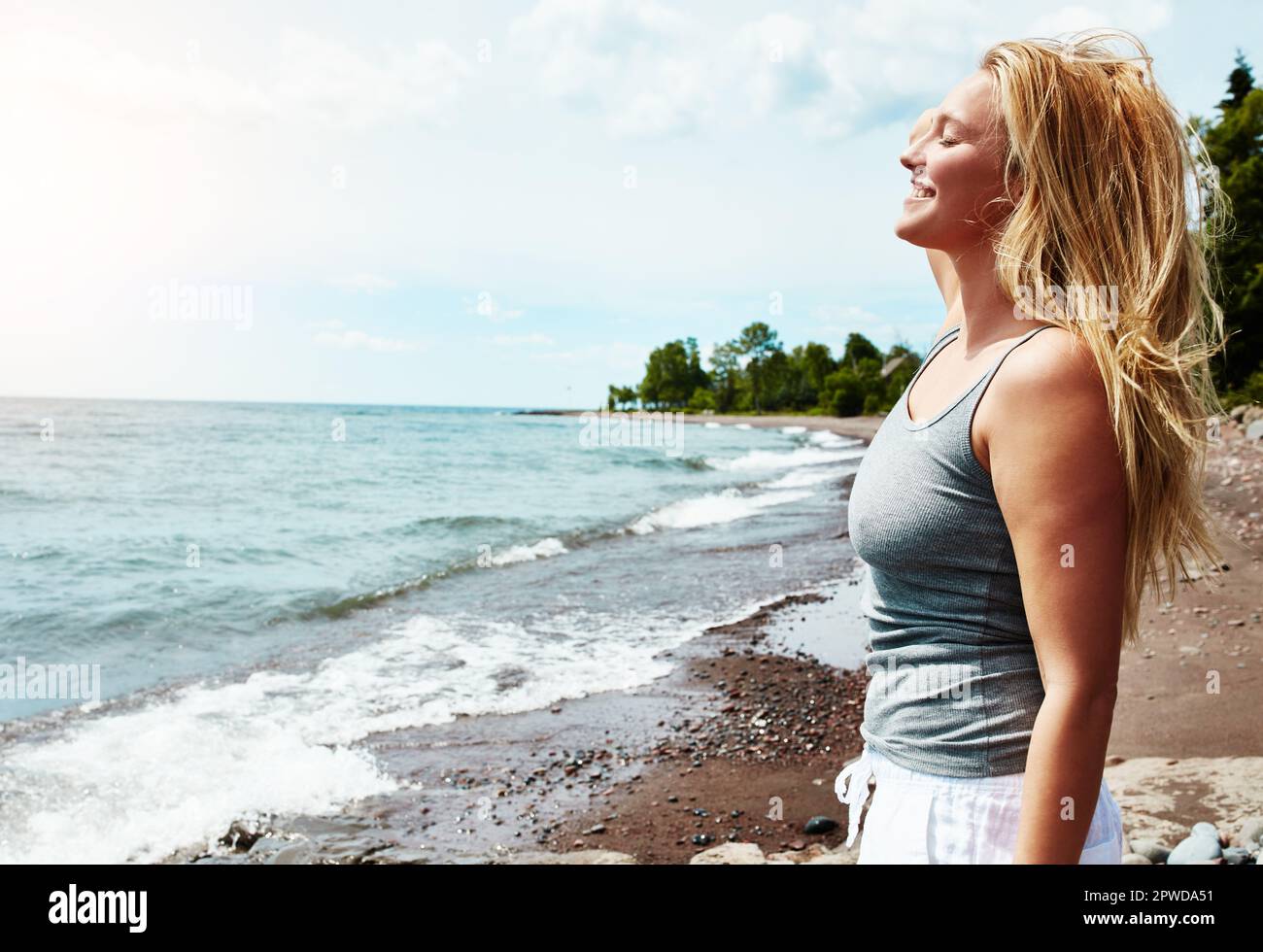 She loves the sun and the sun loves her. a cheerful young woman ...