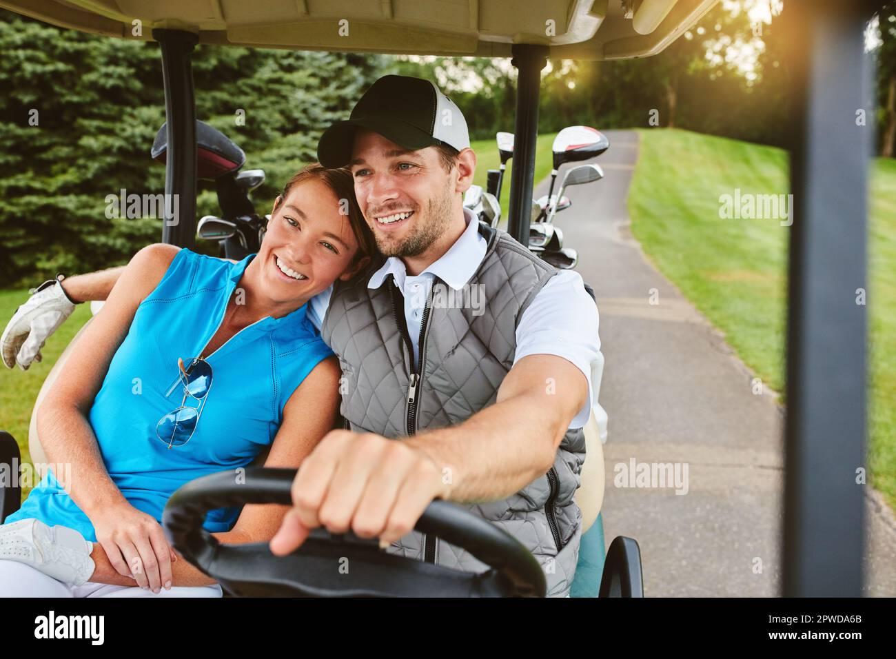 Happy golfers. an affectionate young couple spending a day on the golf ...