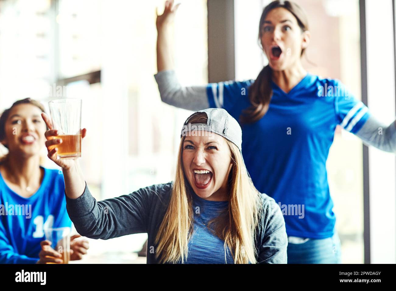 Our team is kicking some ass today. three excited friends cheering on ...