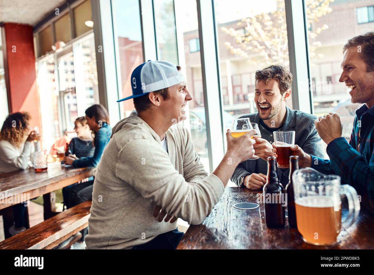 Getting drinks with my mates. three male friends having drinks in a bar ...