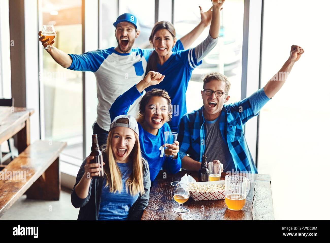 We always get together when its match day. a group of friends cheering ...