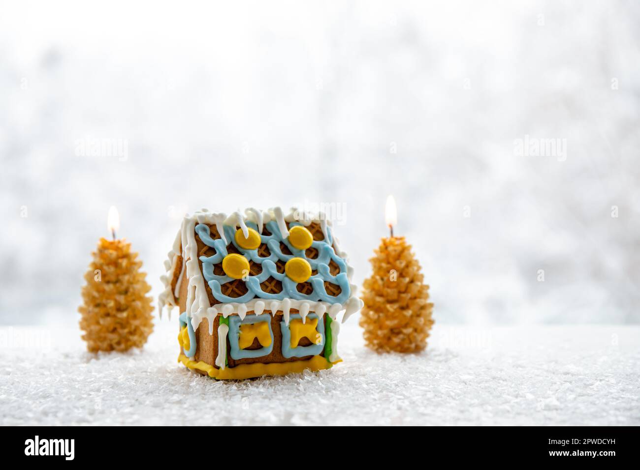 Cute little gingerbread house with, decorated with yellow and blue ...