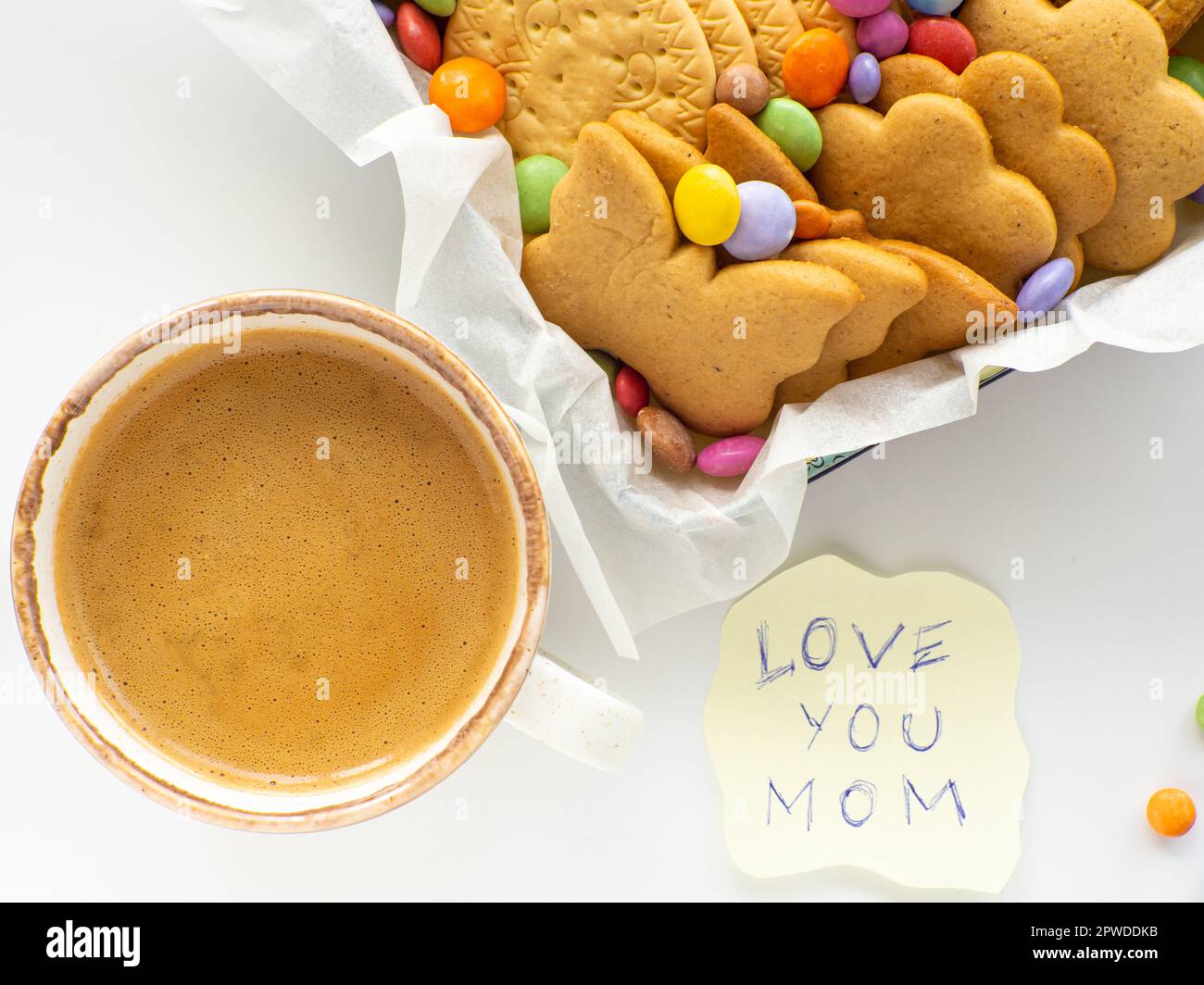 Assorted cookies and candies in basket with Love you mom note. Mothers ...