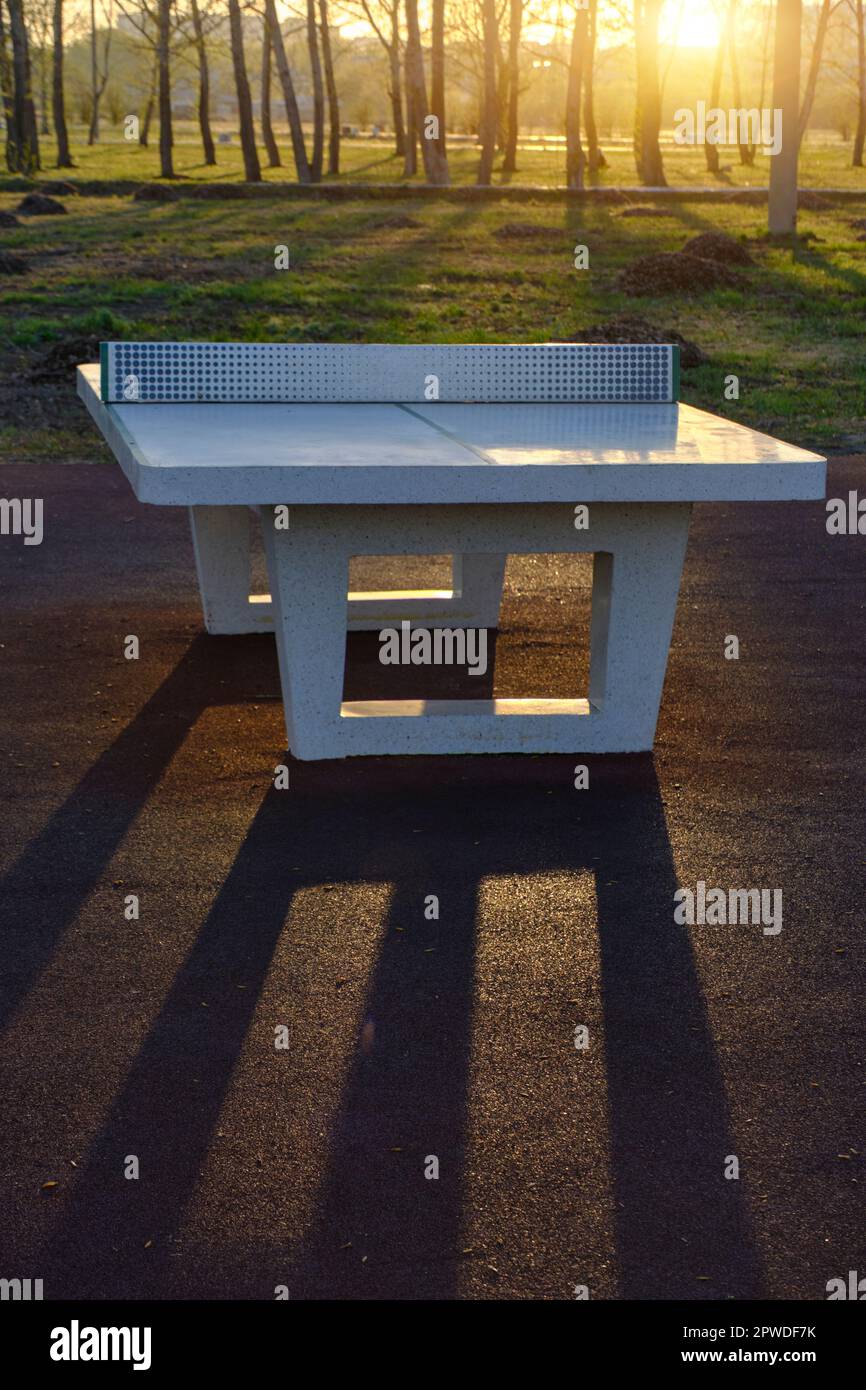Tennis table in public park against sunset Stock Photo - Alamy
