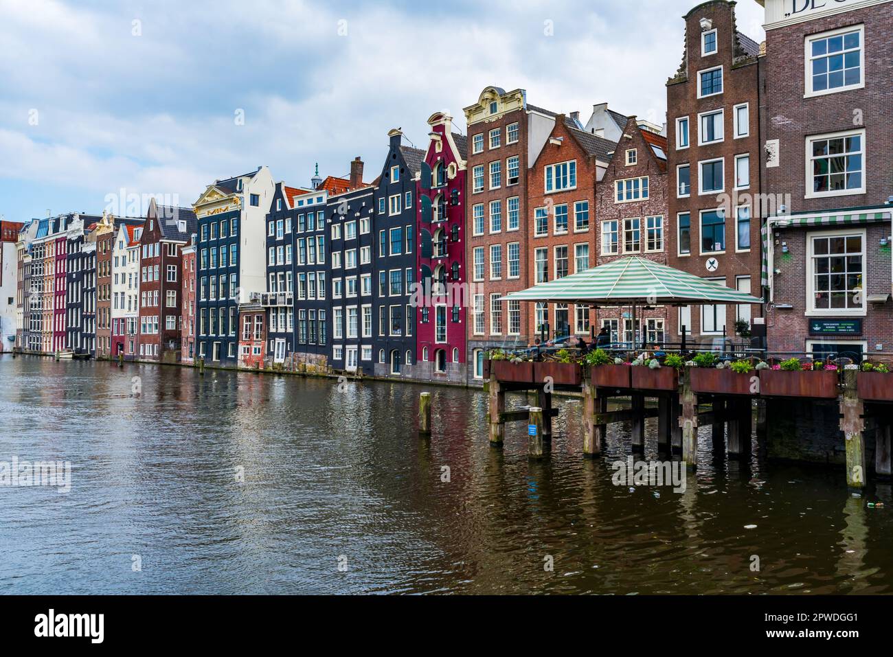 AMSTERDAM, HOLLAND - APRIL 18, 2023: Typical dutch houses line a canal ...