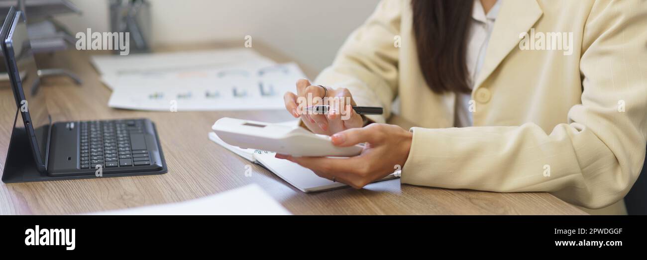 Secretary concept, Female secretary using calculator to calculate ...