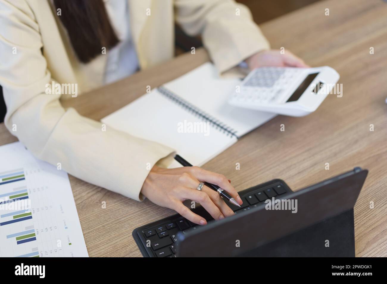 Secretary concept, Female secretary using calculator to calculate ...