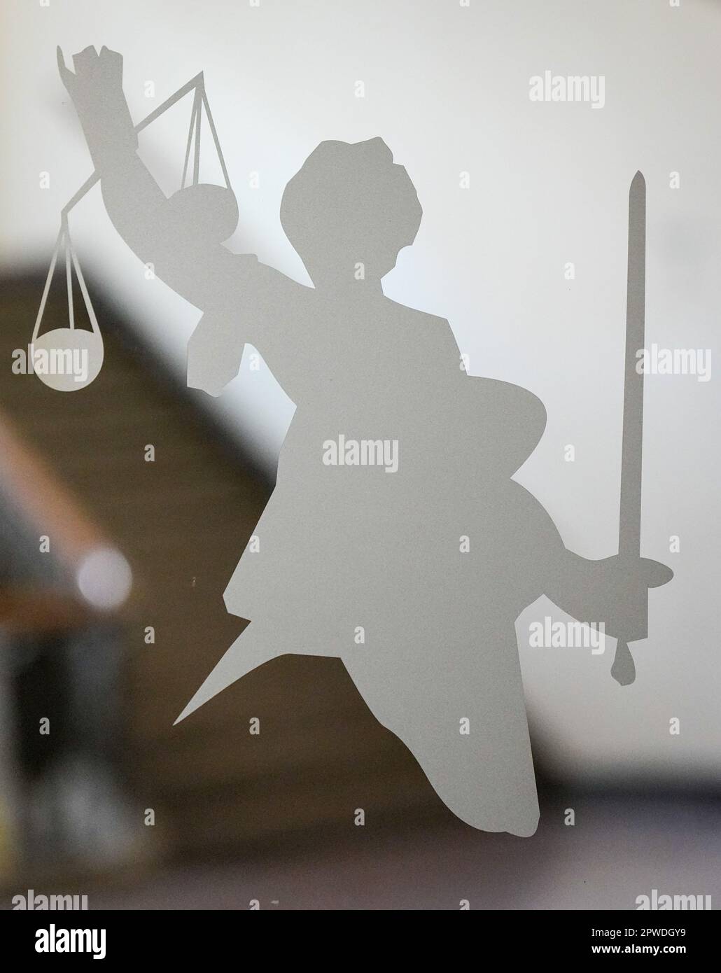 27 April 2023, Berlin: The figure of Justice with a sword and scales ...