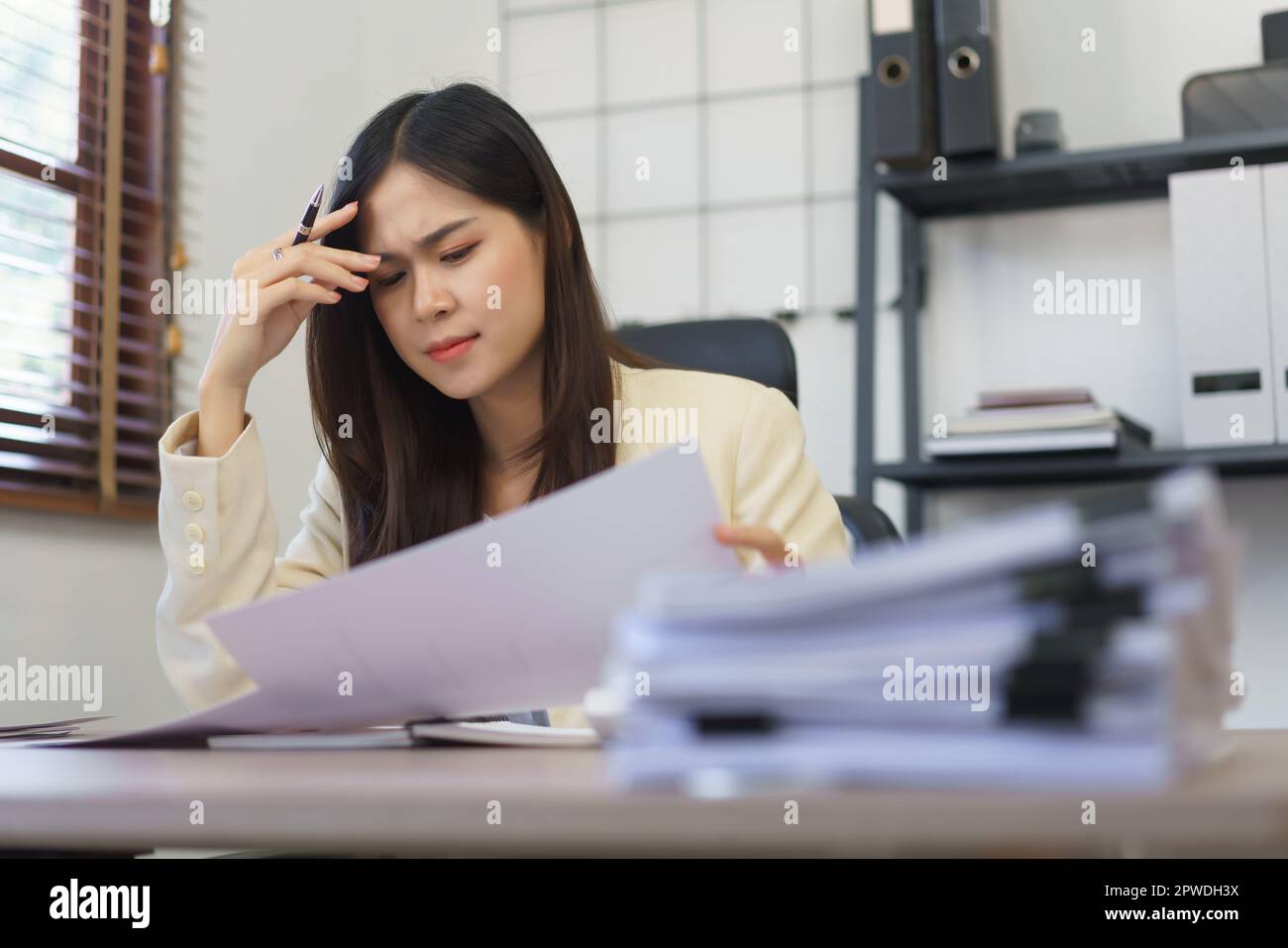 Secretary concept, Female secretary feeling stressed and headache while ...
