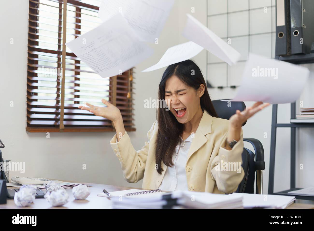 Secretary concept, Female secretary screaming and throwing paper while ...