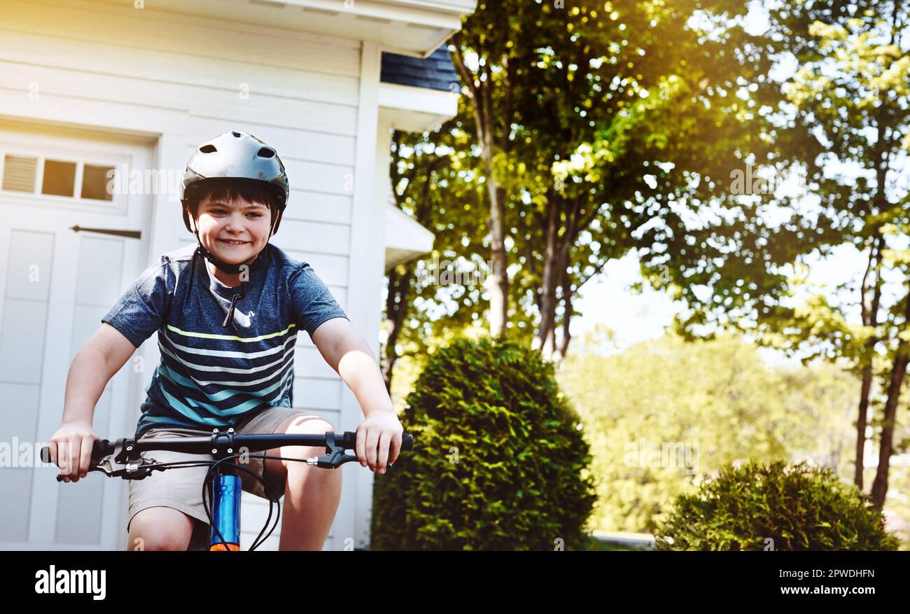 Let me show you some of my awesome biking skills. a young boy riding ...