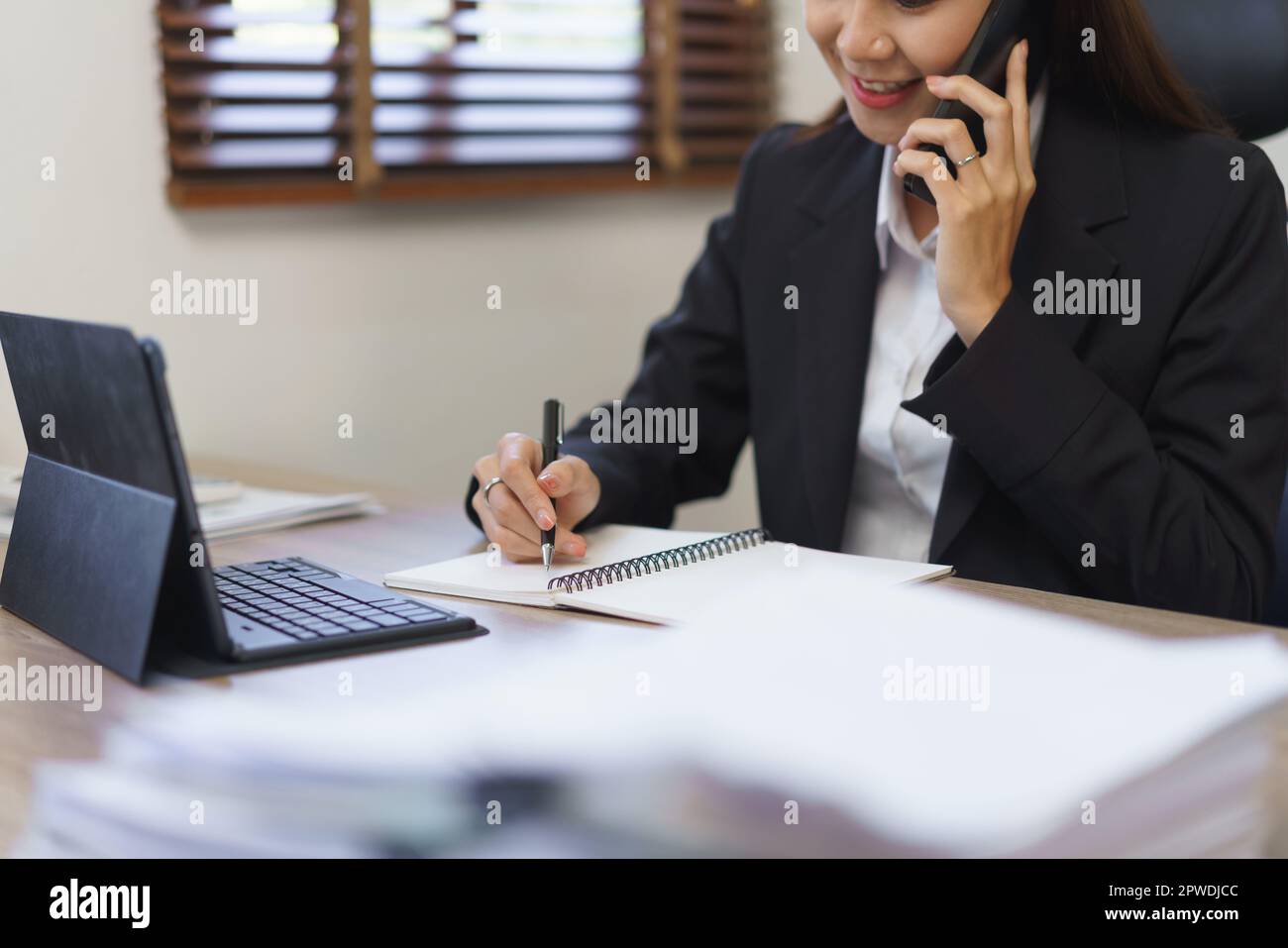 Secretary concept, Female secretary talking on phone with executive and ...