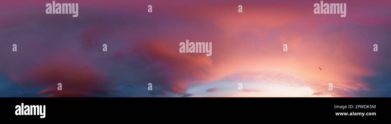 Sunset sky panorama with dramatic bright glowing pink Cumulus clouds ...