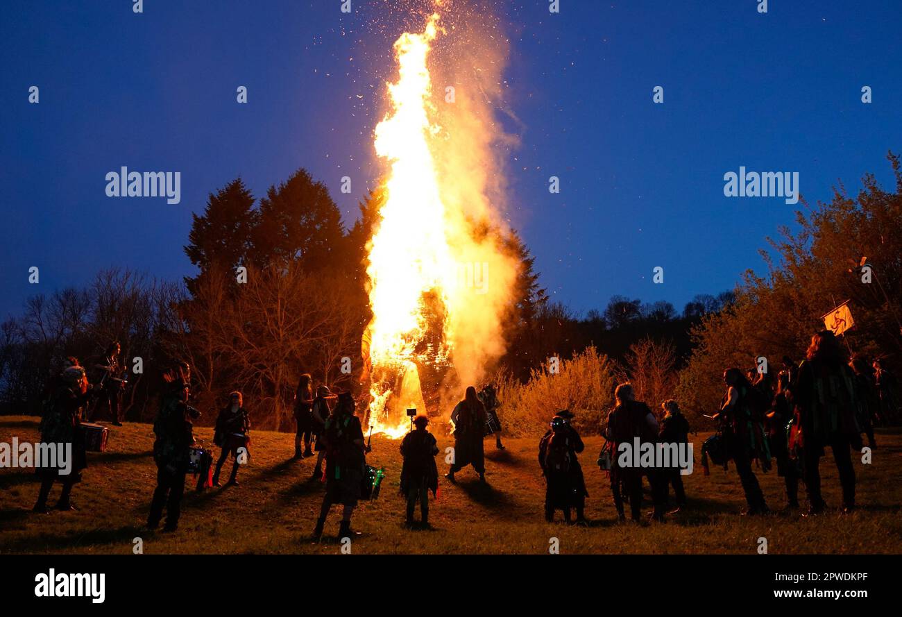 Members of the Pentacle Drummers perform in front of a burning wicker ...