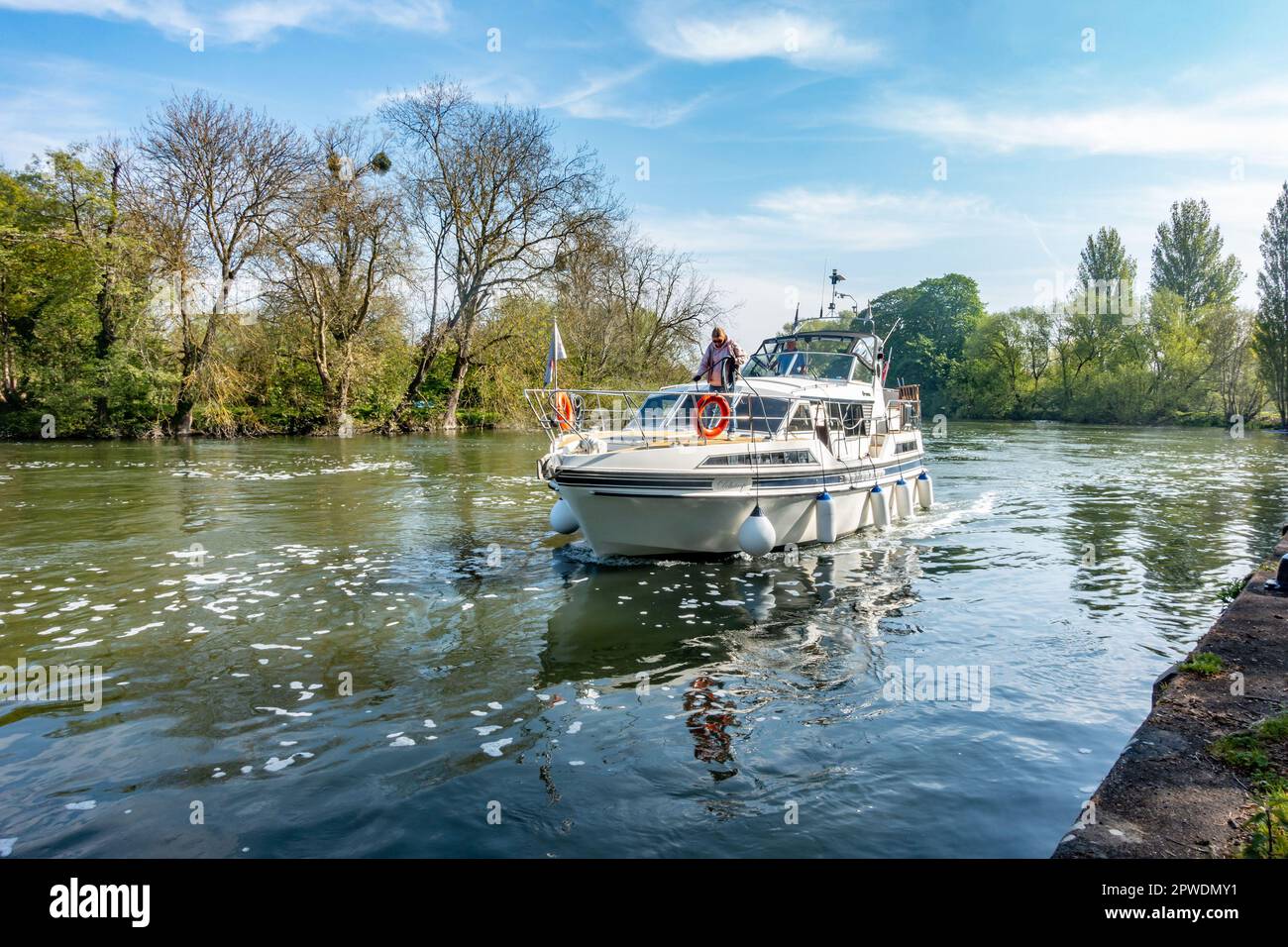 A pleasure boat cruising along The River Thames at Reading in Berkshire ...
