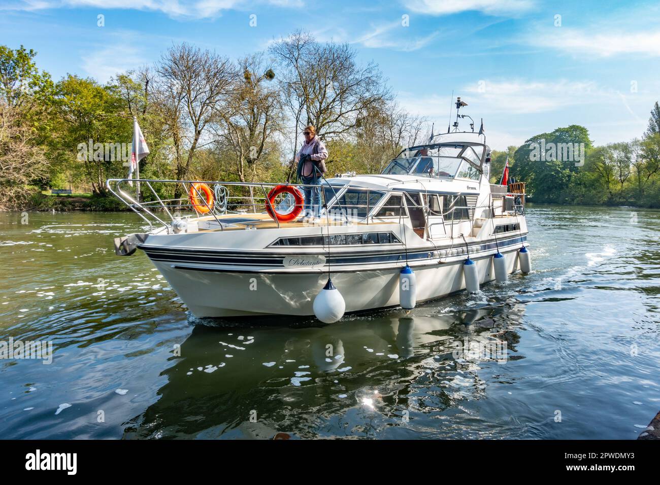 A pleasure boat cruising along The River Thames at Reading in Berkshire ...