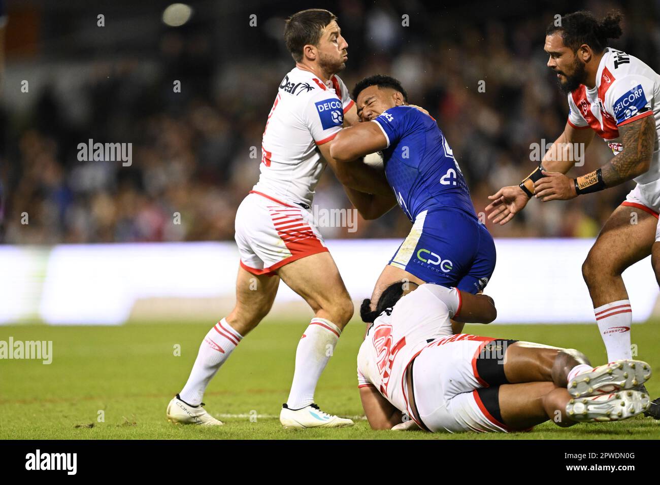 Ben Hunt and Mosese Suli of the Dragons tackle Paul Alamoti of the ...