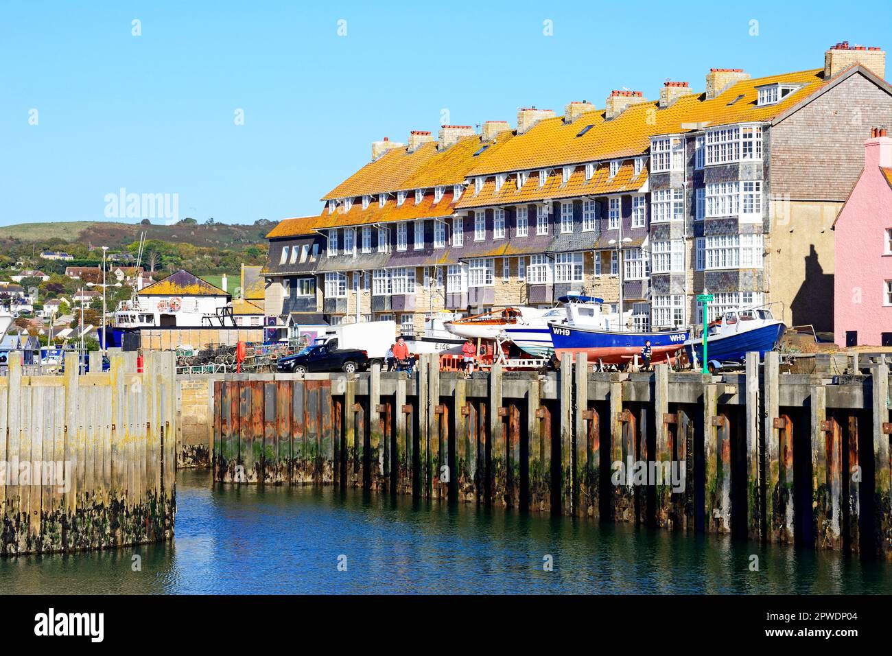 Boats in dry dock on the edge of the harbour with apartments to the ...