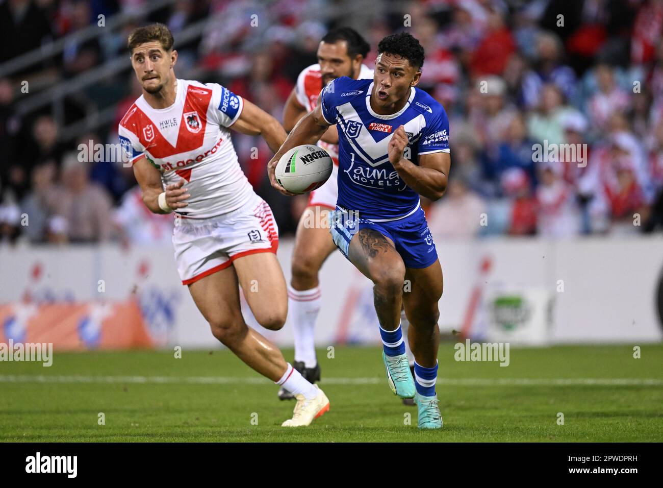 Hayze Perham of the Bulldogs evades Zac Lomax of the Dragons during the ...