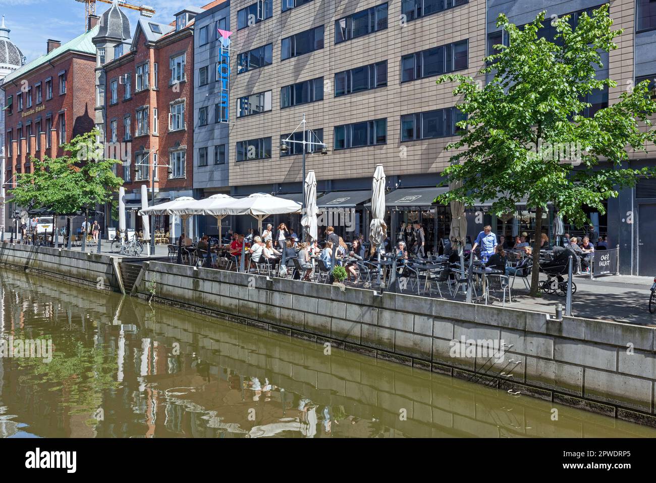 People in bars, cafes and restaurants on the River Aarhus riverside ...