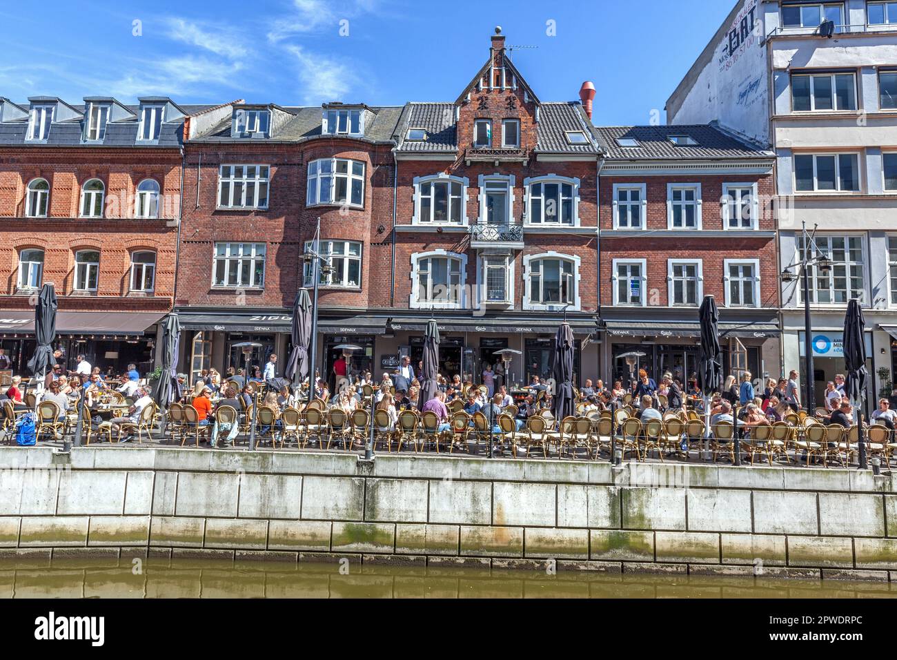 People in bars, cafes and restaurants on the River Aarhus riverside ...