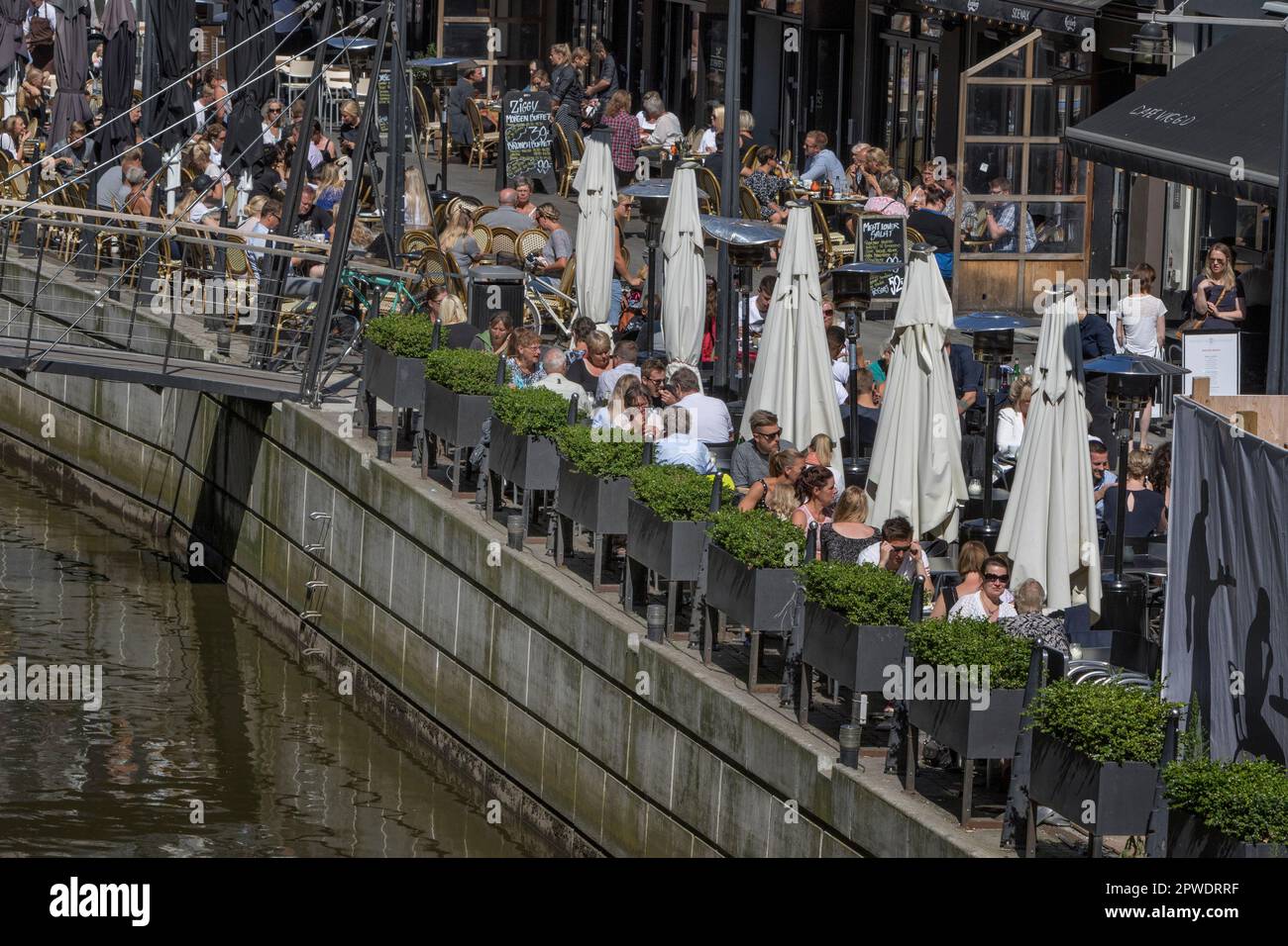 People in bars, cafes and restaurants on the River Aarhus riverside ...