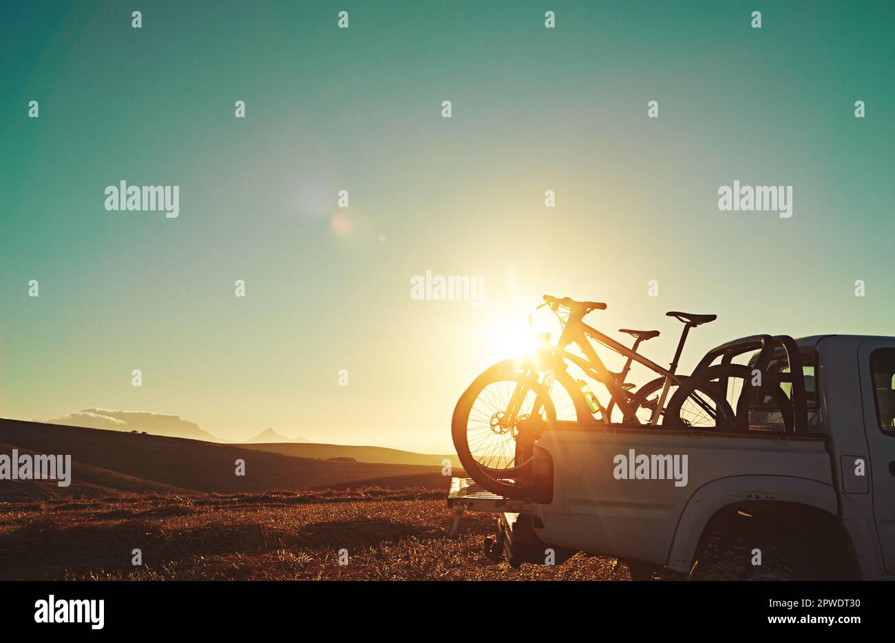 Go see the wild spaces. two bicycles on the back of a truck in the ...