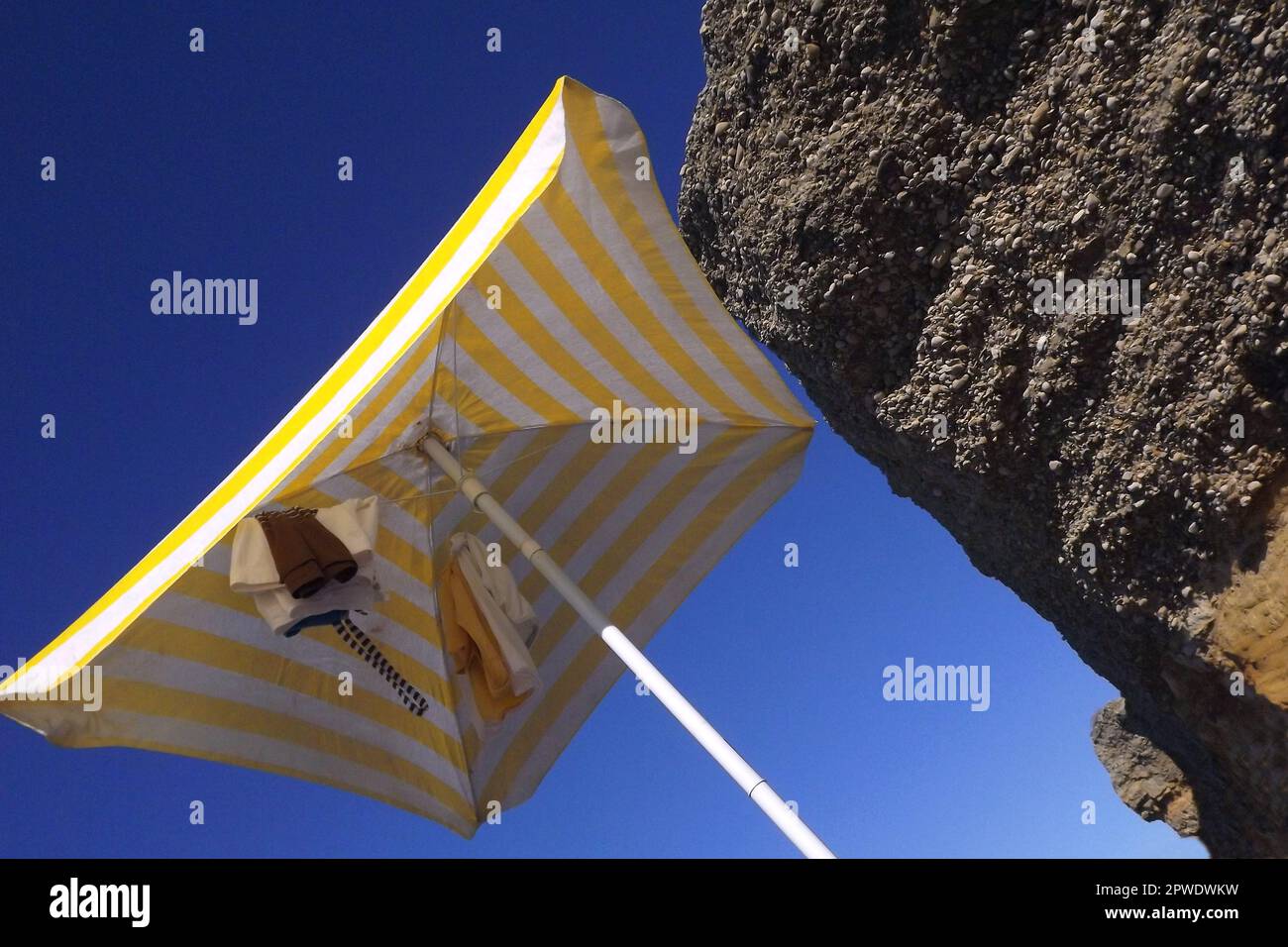 Square beach umbrella with blue sky on background Stock Photo - Alamy
