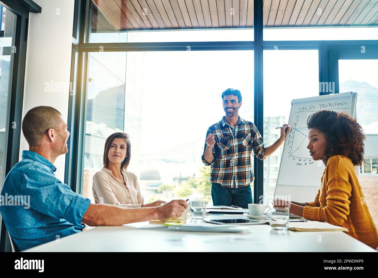 Delivering an expert presentation. a young businessman giving a ...